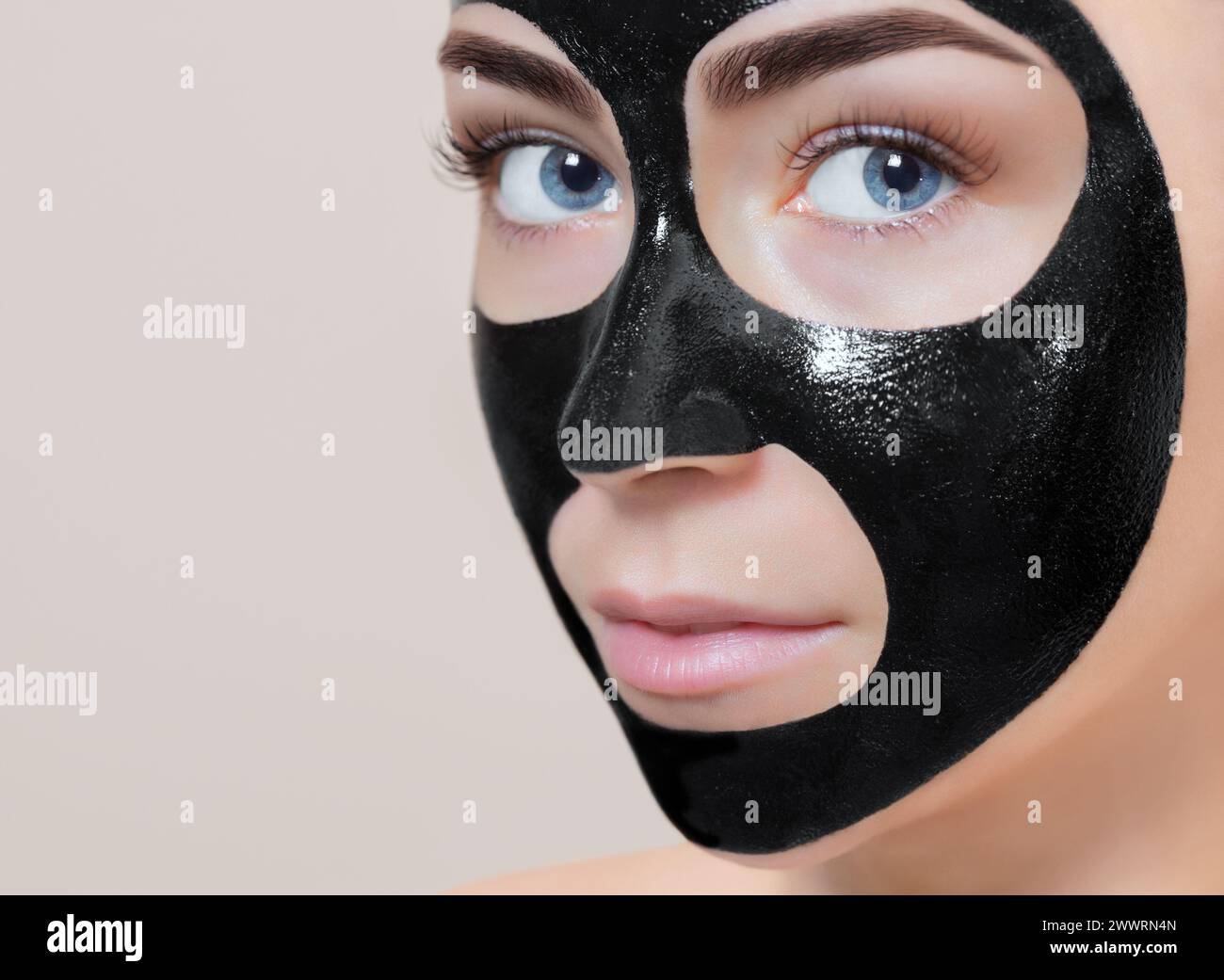 Facial black Mask to the face of a beautiful woman. Spa treatments and ...