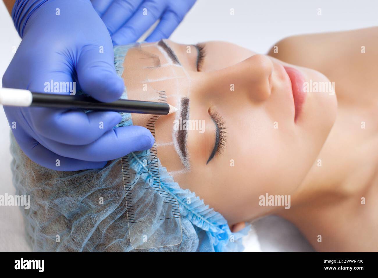 Permanent make-up for eyebrows of beautiful woman with thick brows in ...