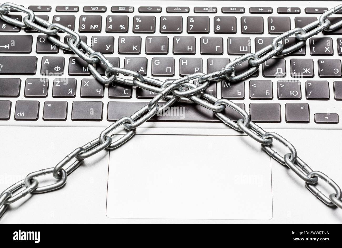 Closed laptop computer with chain wrapped around it and padlocked Stock ...