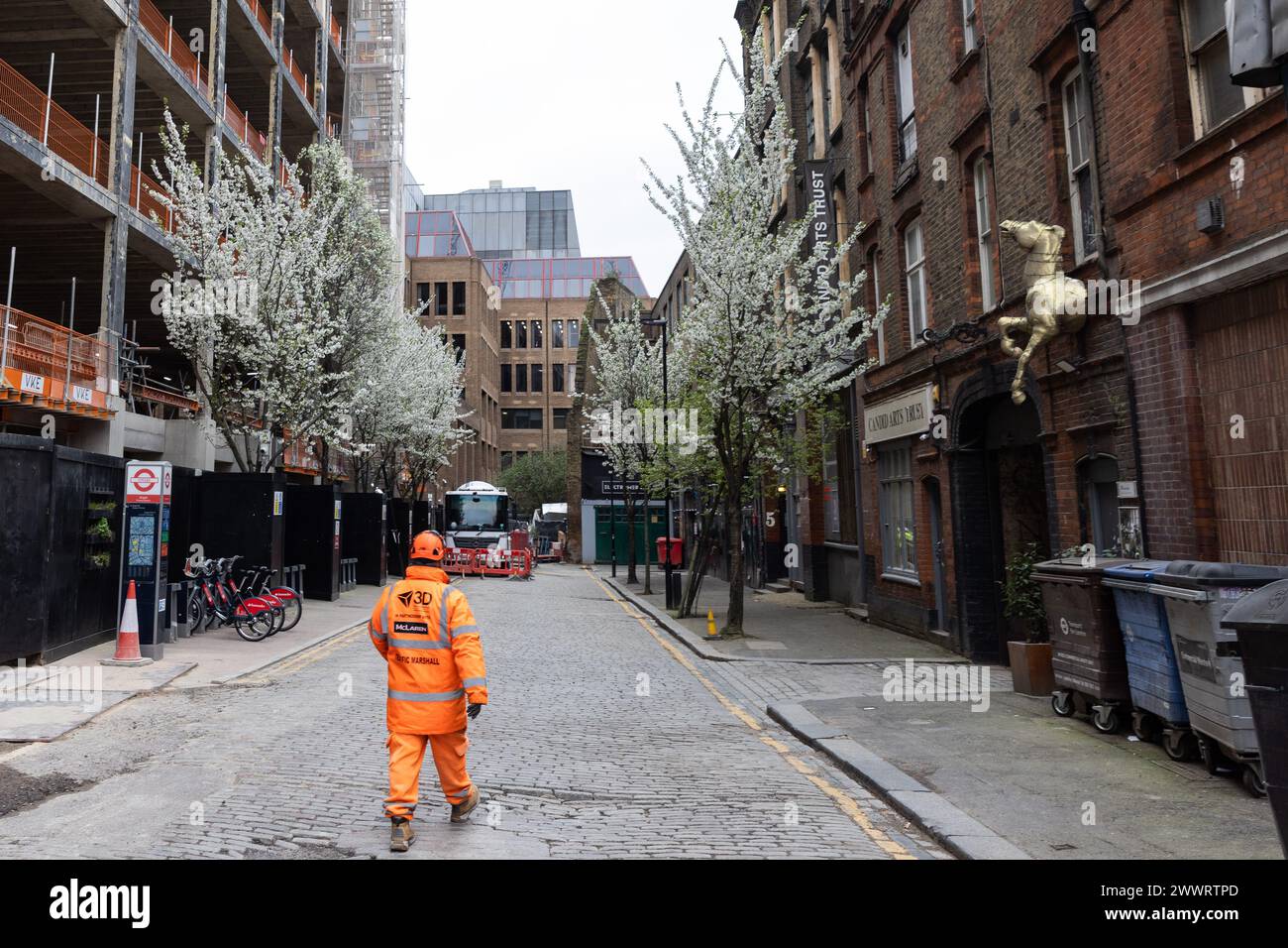 London, UK. 19th March, 2024. A construction worker walks between the ...