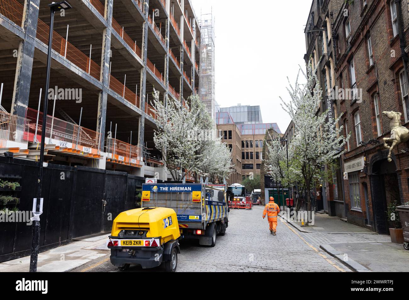 London, UK. 19th March, 2024. A construction worker and truck move ...