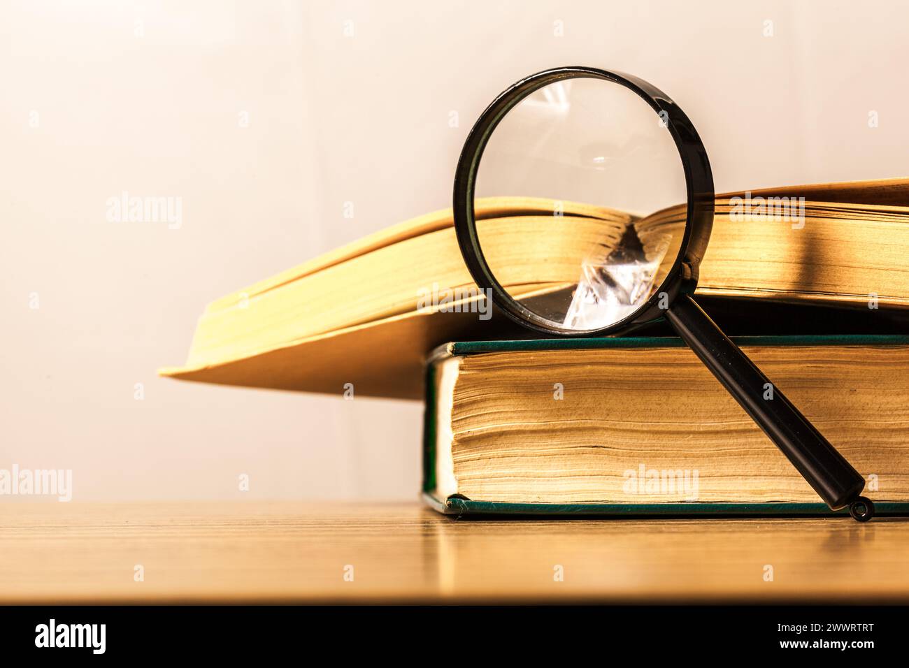books and magnifying glass Stock Photo - Alamy
