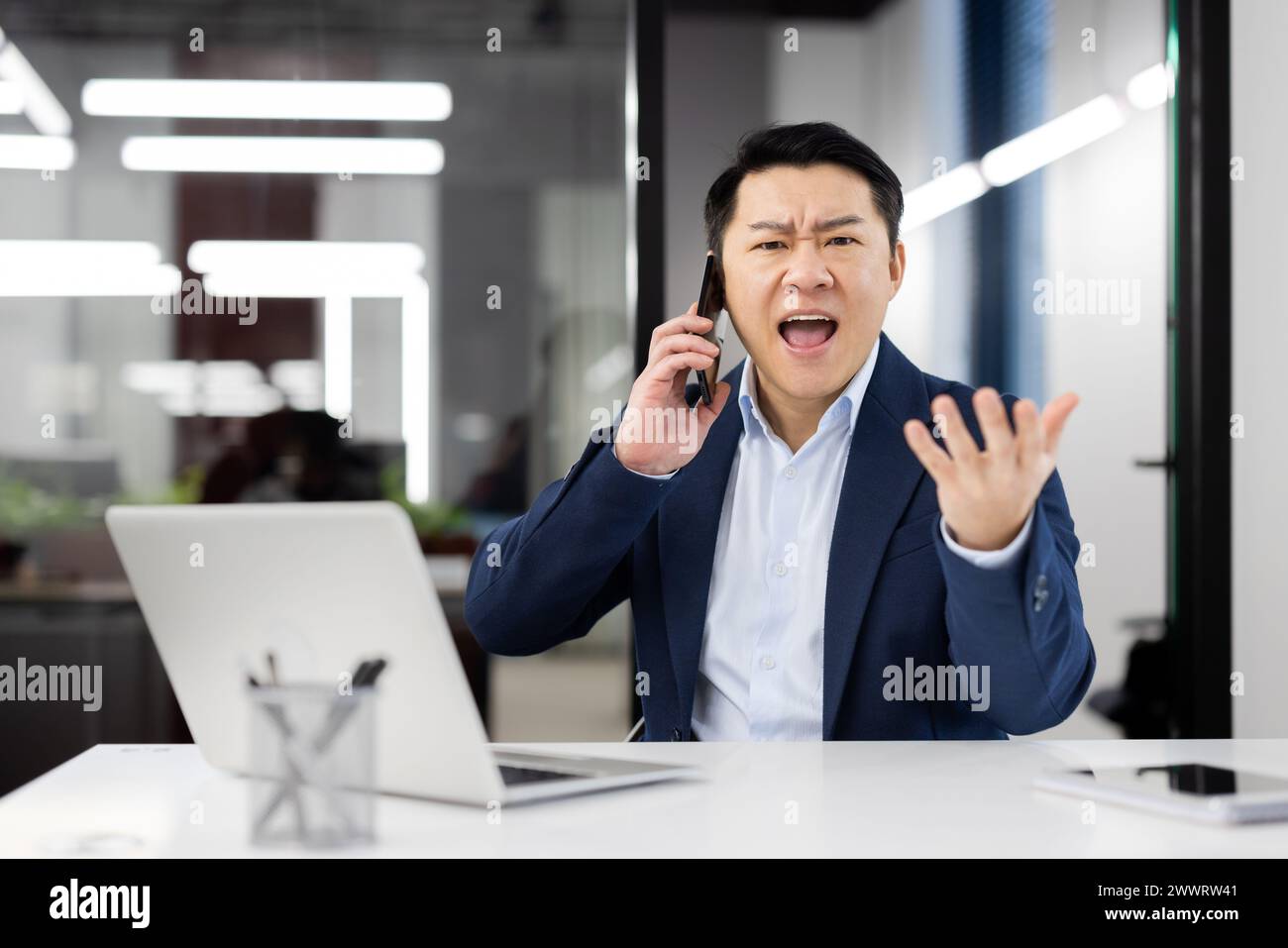Angry chinese man screaming while having conversation on wireless ...