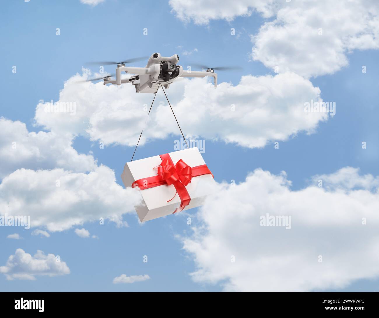 Drone delivering a gift box and flying in a blue sky with clouds Stock ...