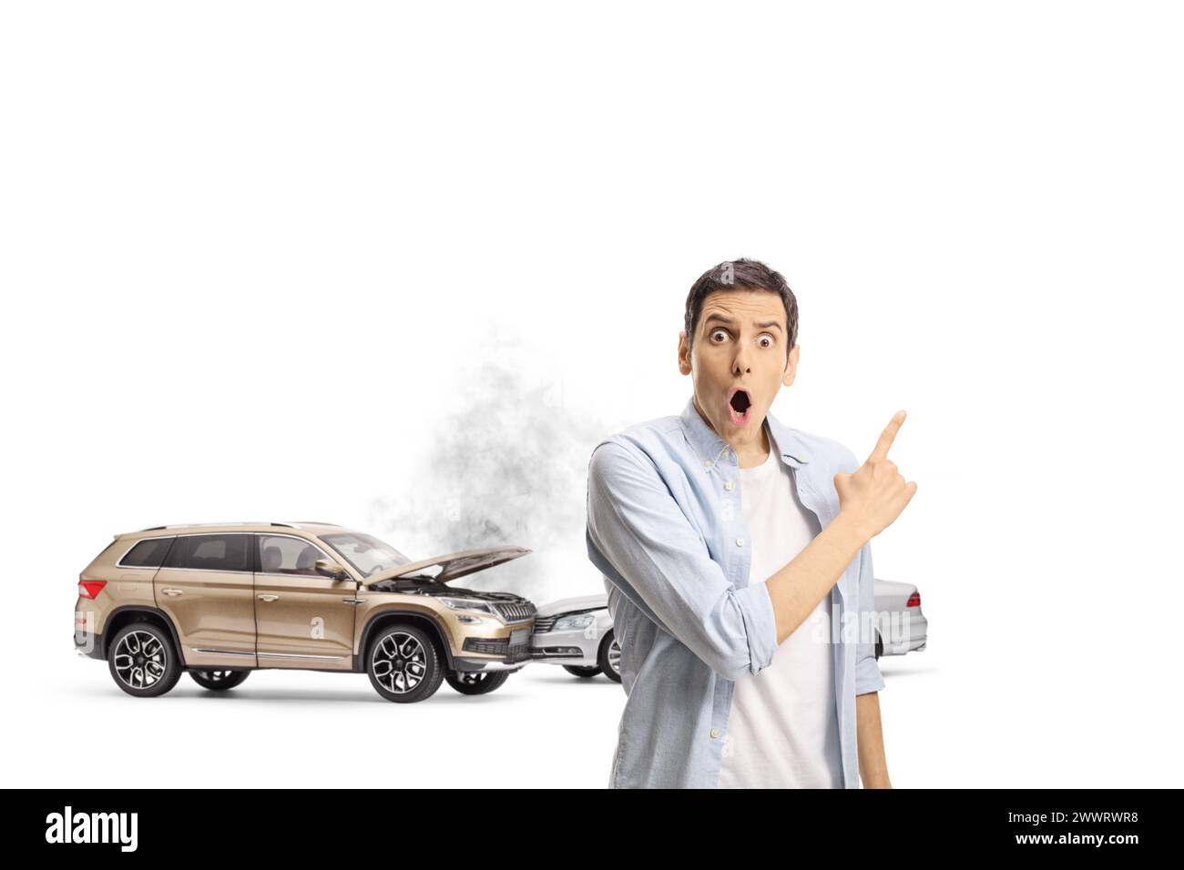 Shocked young man with eyes wide open pointing at a car crash isolated ...