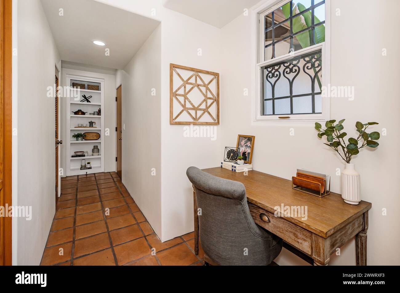 A cozy desk by a window in a compact room Stock Photo - Alamy