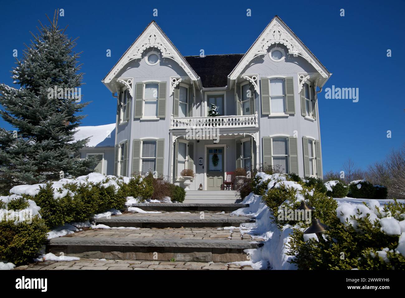 Winter landscape of Victorian style house with deep snow in winter ...