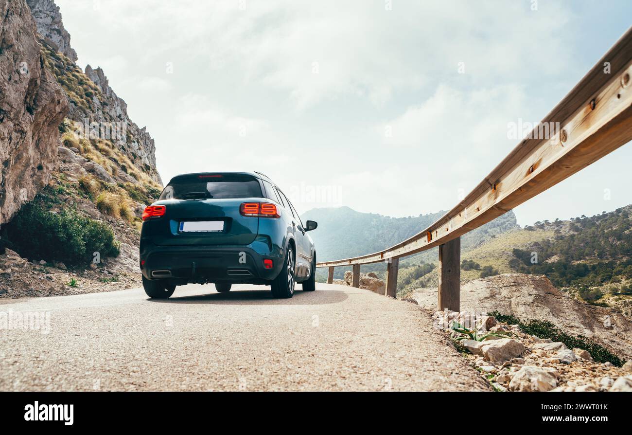 Fast-moving compact auto on the mountain road asphalt road with steel ...