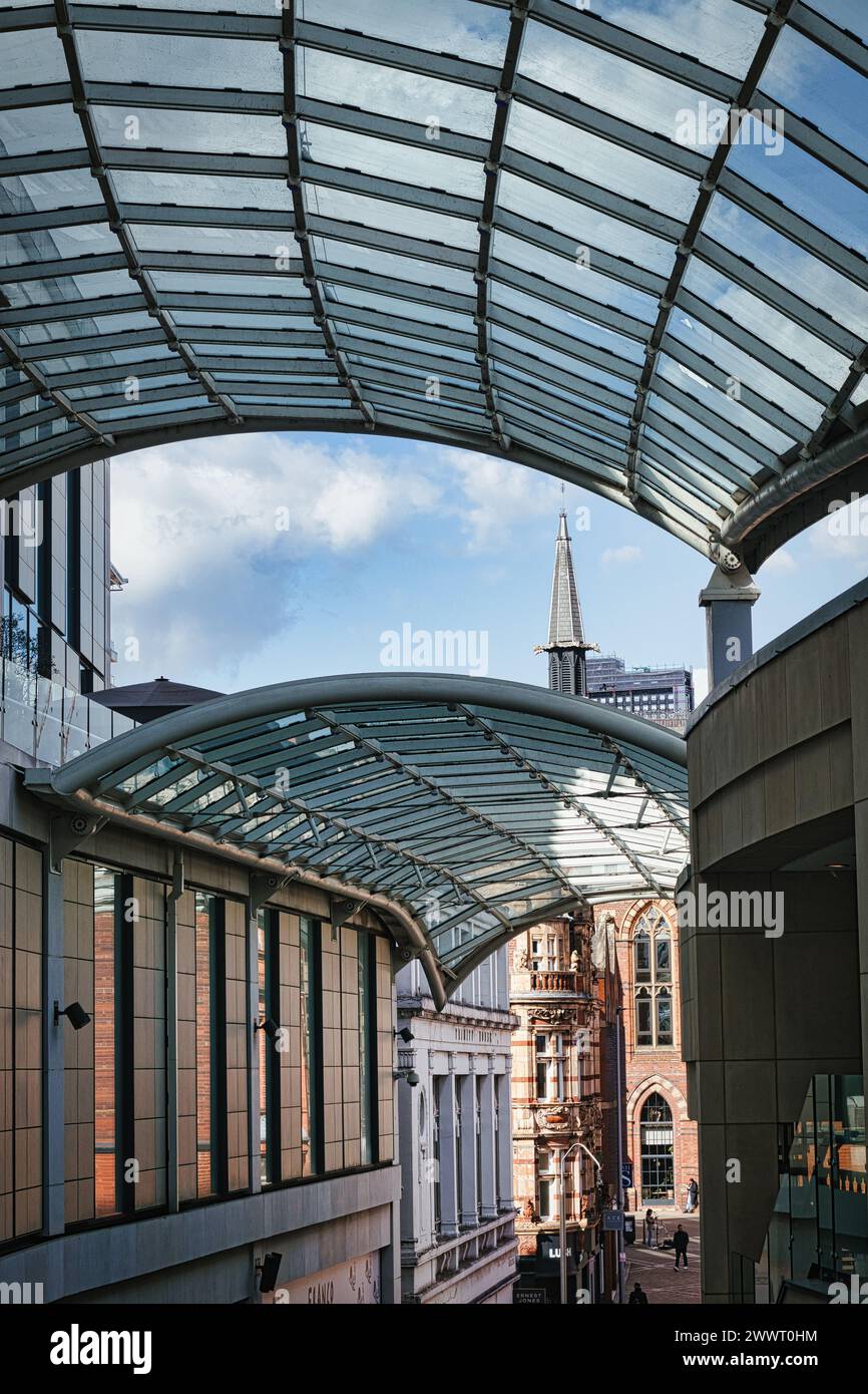 Modern glass canopy over a pedestrian walkway with historic ...