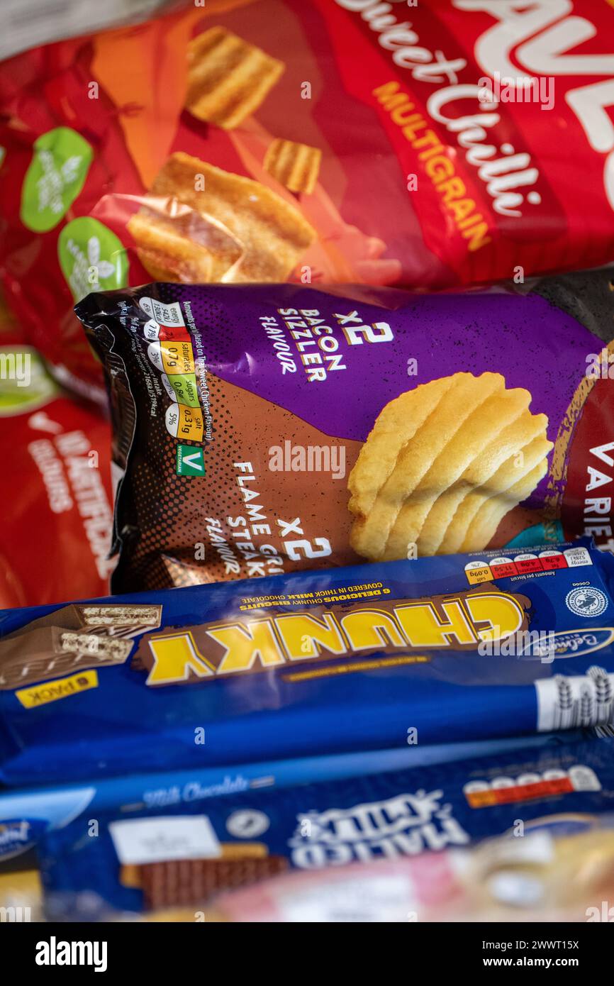Packets of junk food in a shoppers trolley. UK Stock Photo - Alamy
