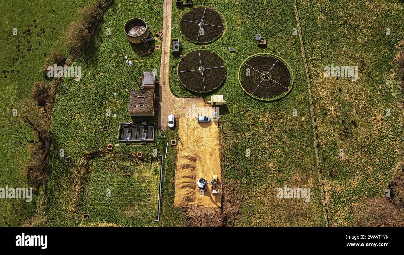 Aerial view of a wastewater treatment plant with circular tanks in a ...