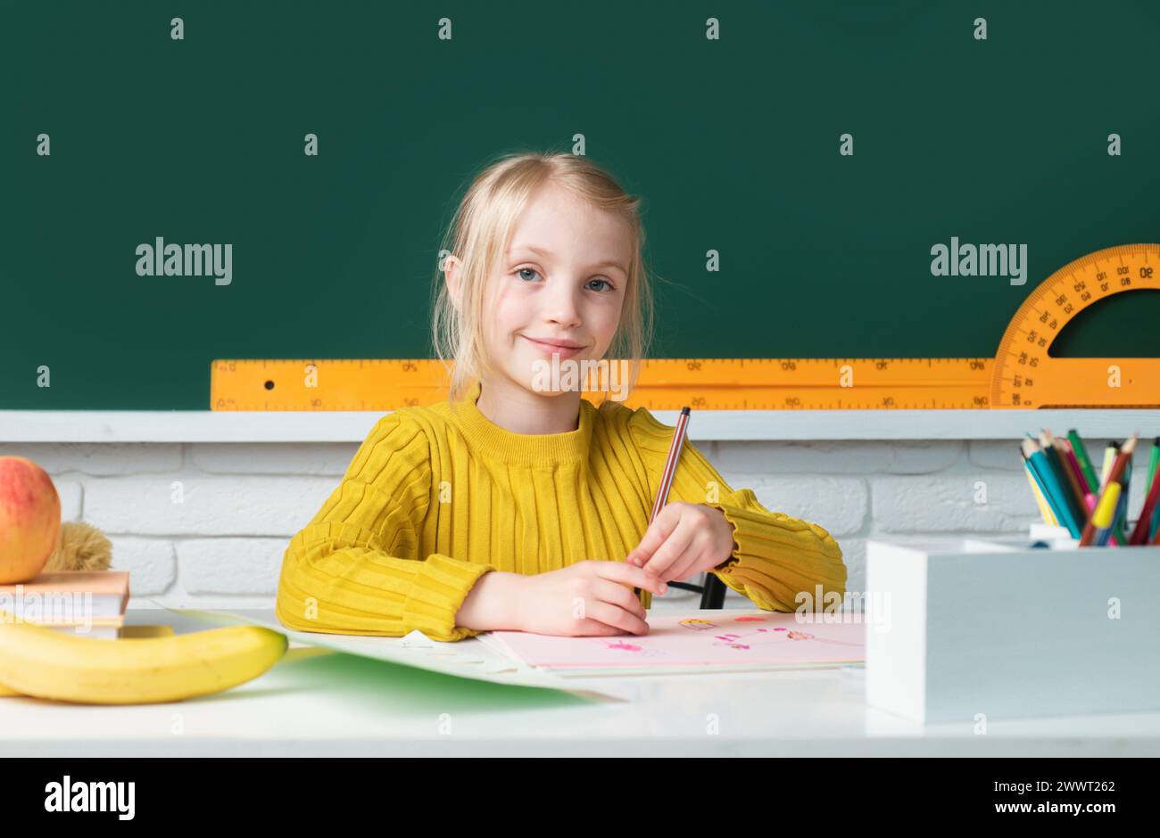School girl studying math on lesson in classroom at elementary school ...