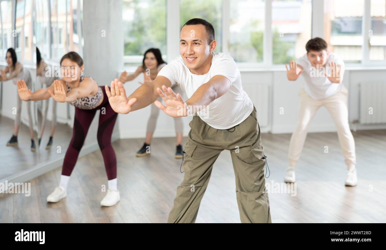 Group of young people warming up before dance class Stock Photo - Alamy