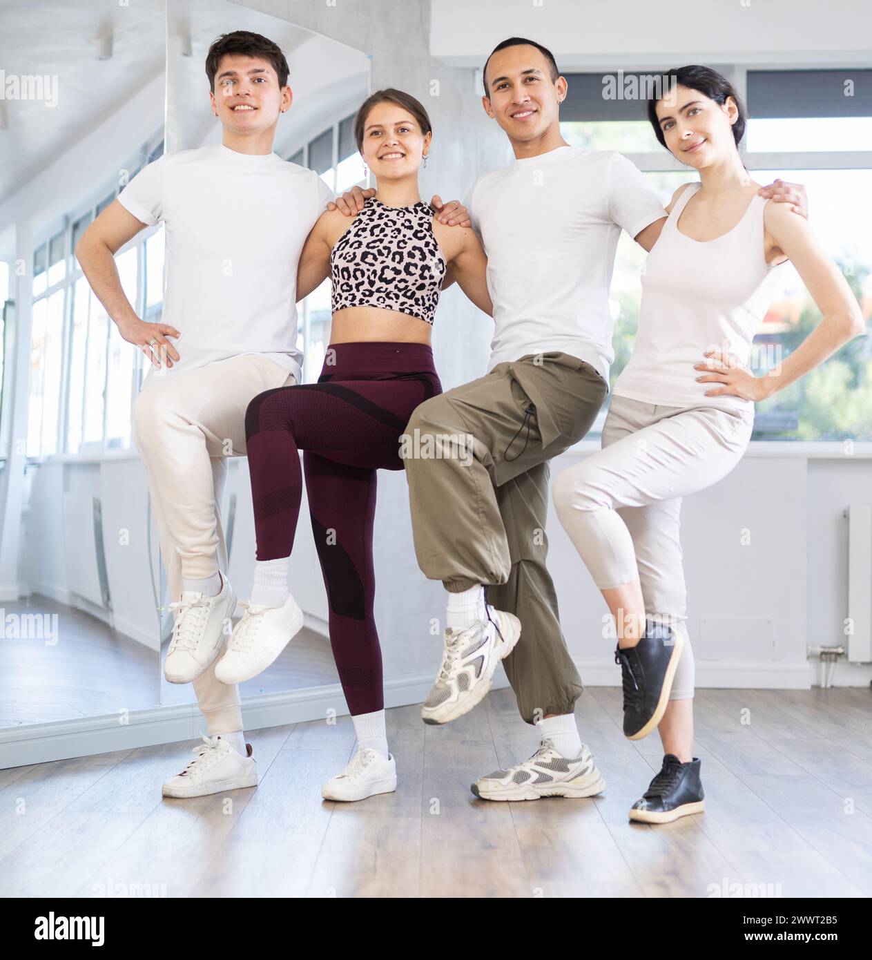 Group happy girls and guys dancing folk dance in row in studio Stock ...
