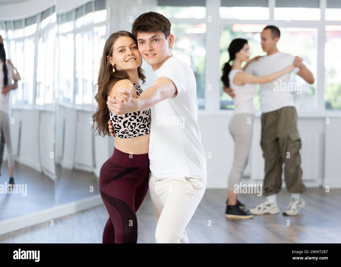 Dance studio - students in casual clothes learn to dance tango Stock ...