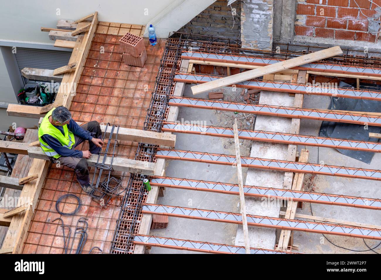 A construction worker prepares the steel reinforcement before pouring ...