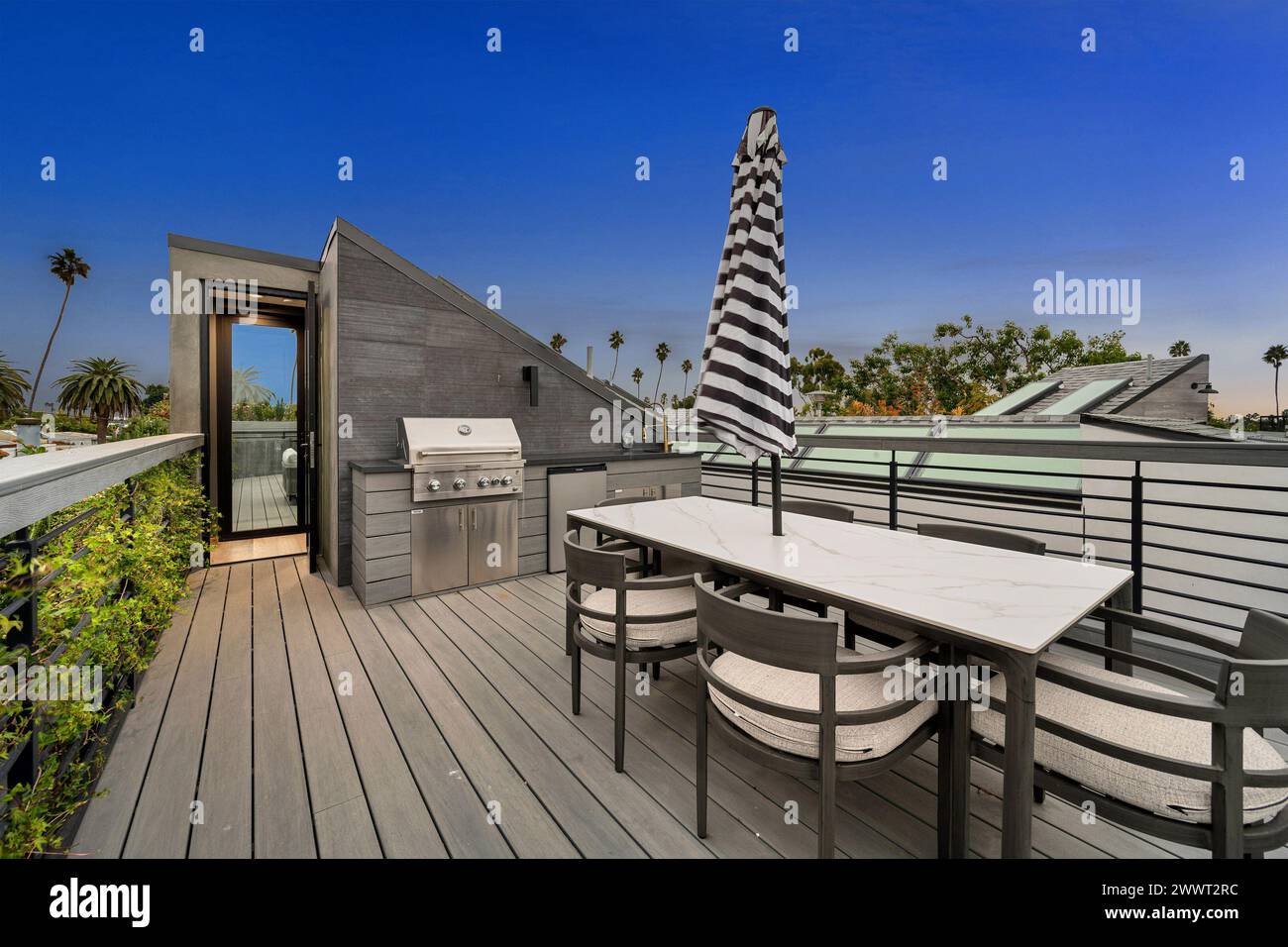 An outdoor patio design with various furniture under a bright blue sky ...