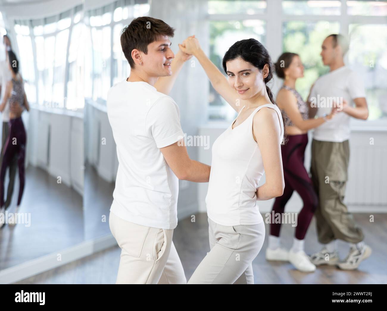 Girl paired up with young man, they train to perform hustle dance ...