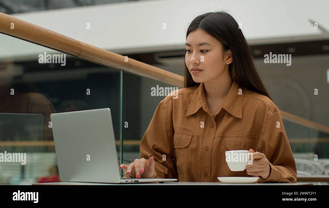 Asian woman businesswoman use computer internet in cafe chinese korean ...