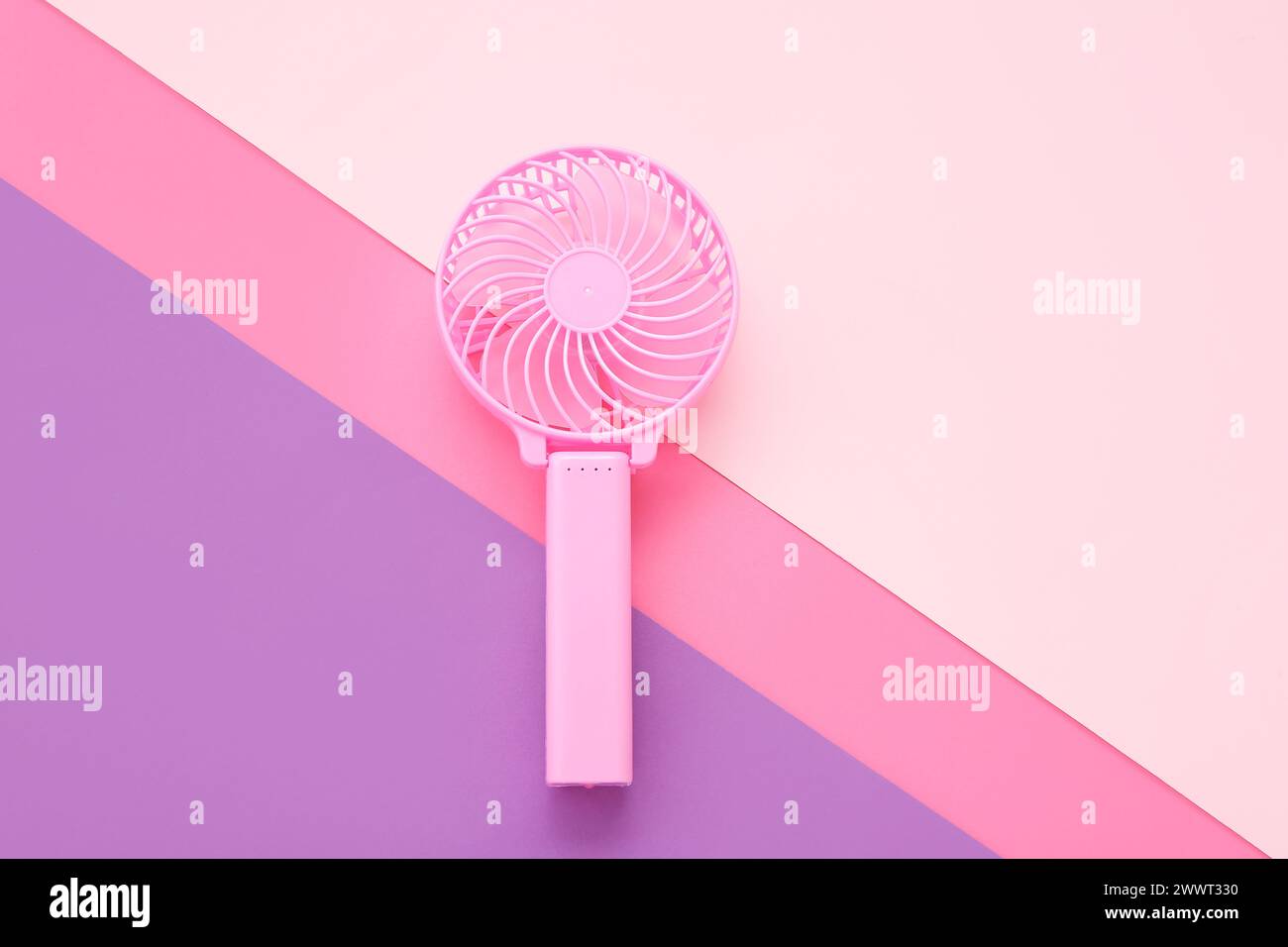 Portable pink electric fan on colorful background Stock Photo - Alamy