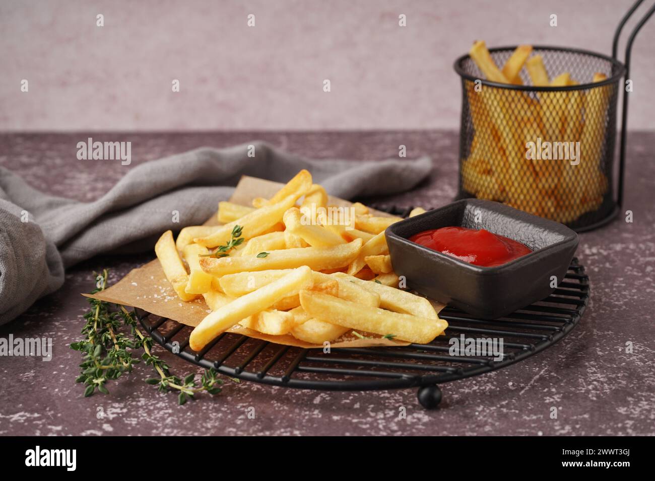 Grid with tasty french fries and ketchup on grey background Stock Photo ...