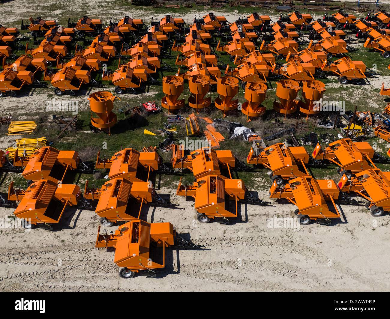 Aerial view of the storage area of orange coloured balers produced by a ...