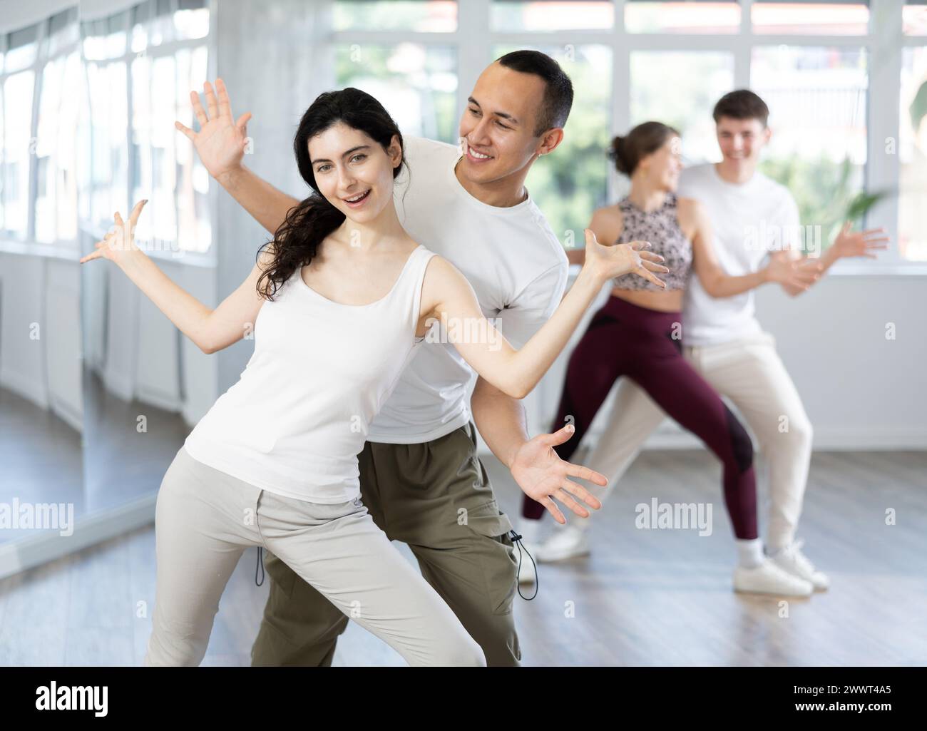 Girl paired up with young man, they train to perform hustle dance ...