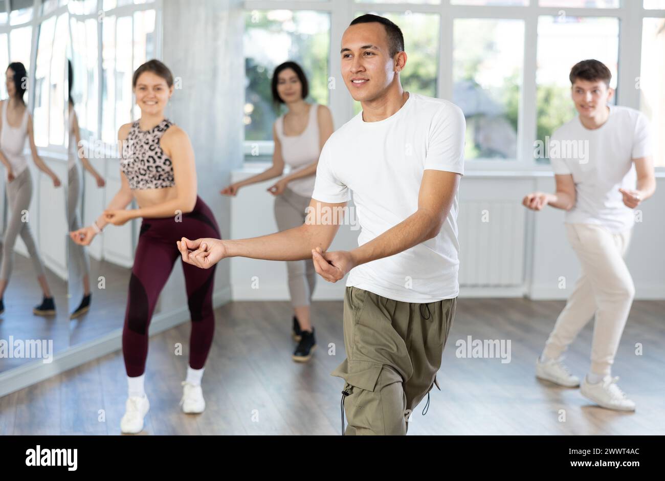 Guy enjoys active dancing, learns new movements, moves synchronously ...