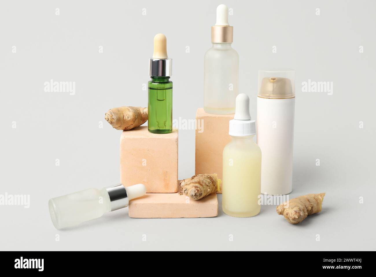 Composition with bottles of cosmetic products, ginger and plaster ...