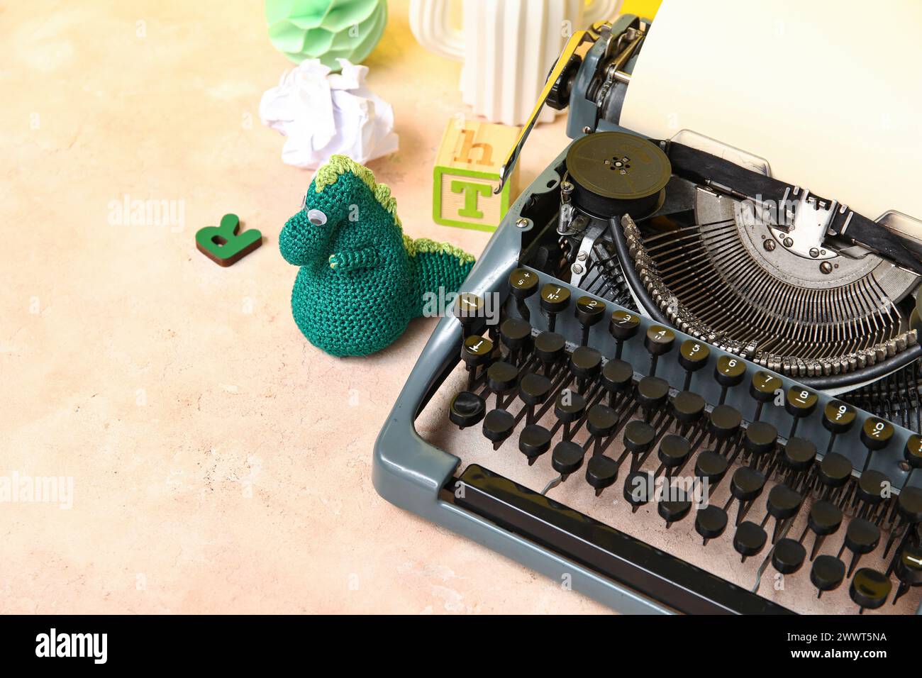 Composition with vintage typewriter with knitted toys on beige ...