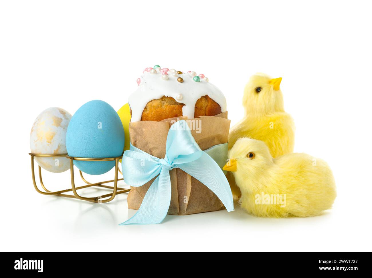 Tasty Easter cake, chicks and holder with eggs on white background ...