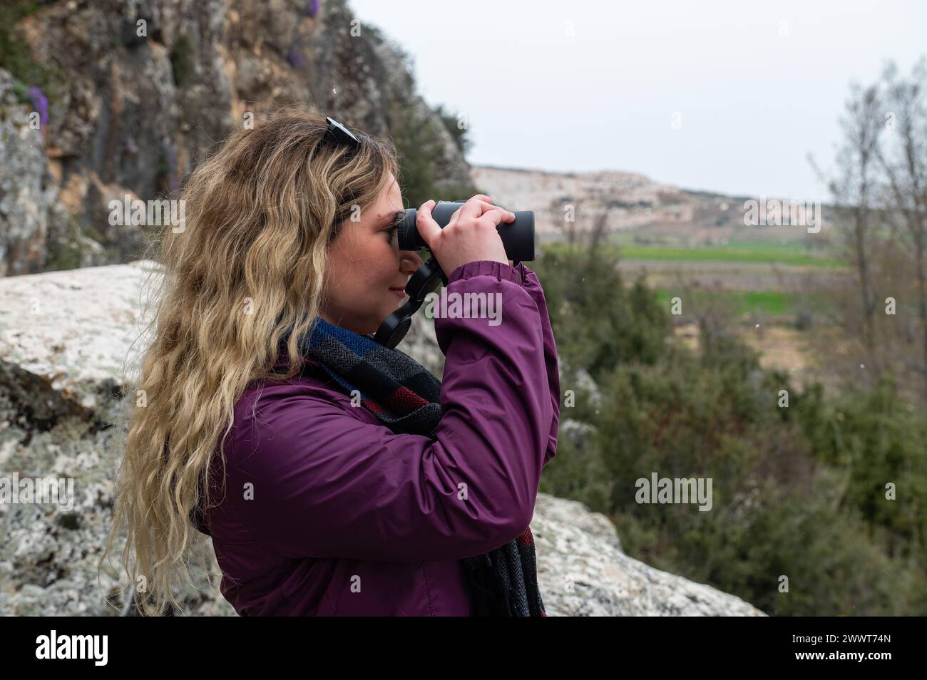 A young girl observing in nature with binoculars Stock Photo - Alamy