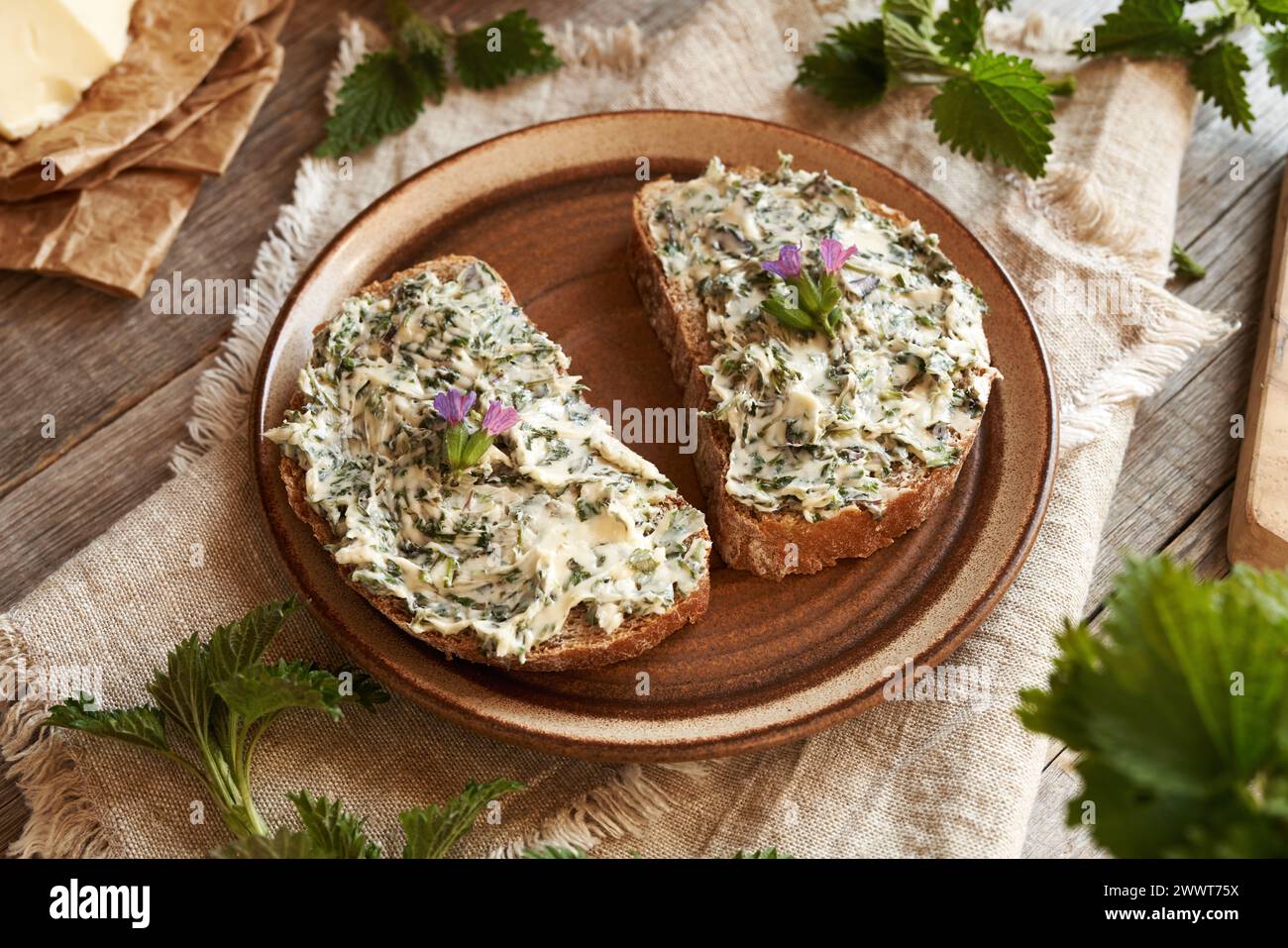 Two slices of sourdough bread with nettle butter - homemade spread made ...