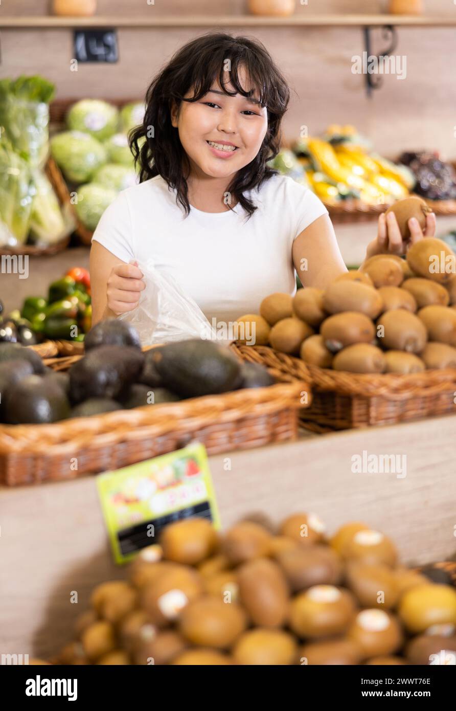 Asian girl choosing fruits in supermarket Stock Photo - Alamy