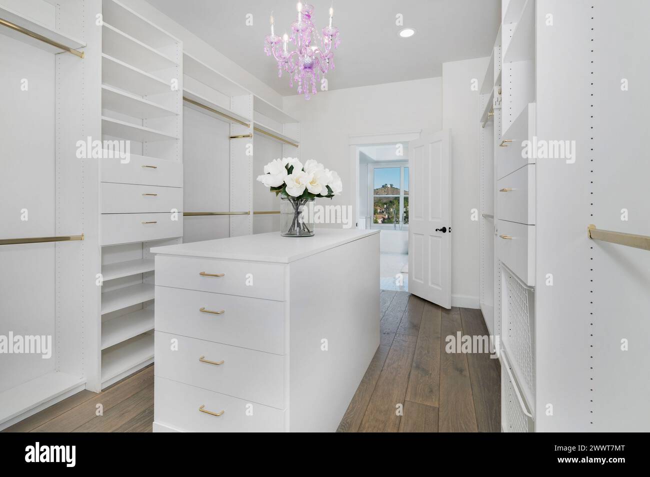 A white closet with open shelves and a large countertop Stock Photo - Alamy