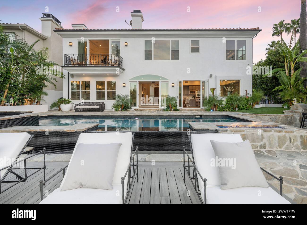 The chaise lounge chairs poolside at a luxurious residence Stock Photo ...