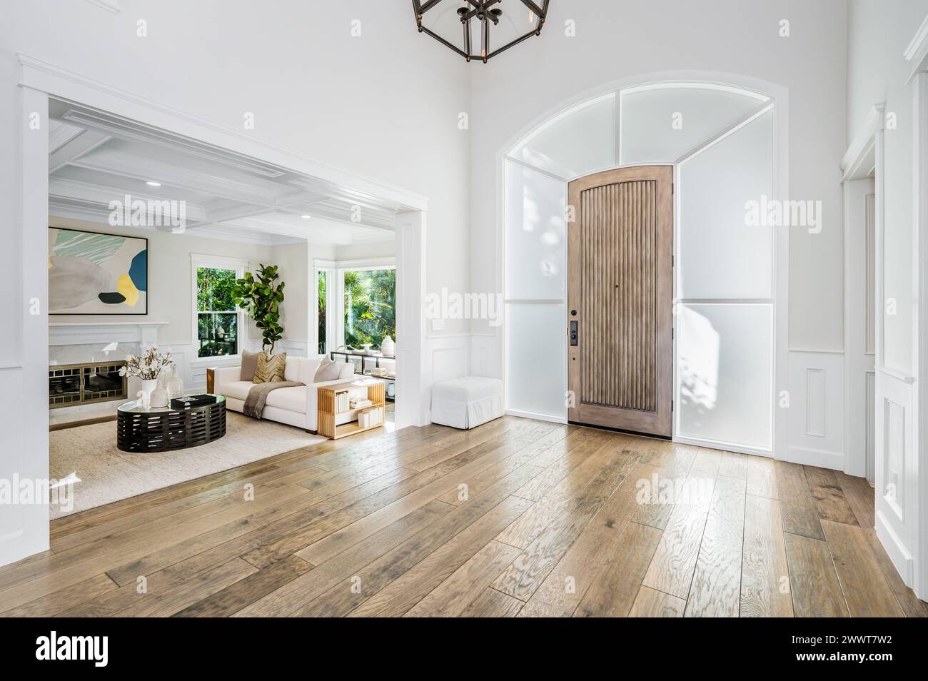 An elegant foyer with wooden floors and a grand entrance Stock Photo ...