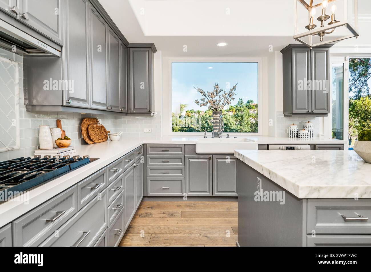 A modern marble kitchen with sleek gray cabinets Stock Photo - Alamy