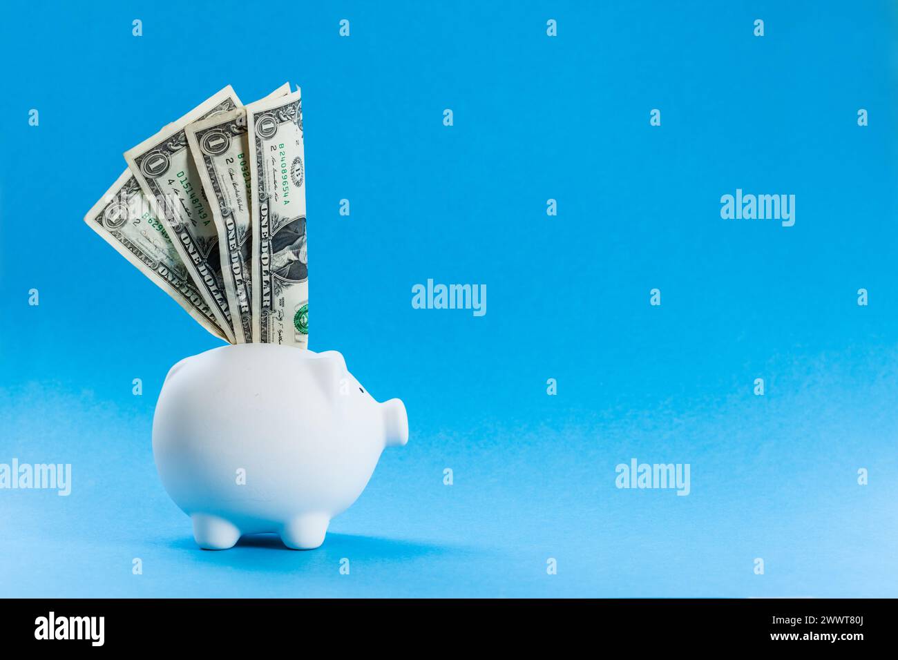 Huge savings in the piggy bank, overflowing with cash Stock Photo - Alamy