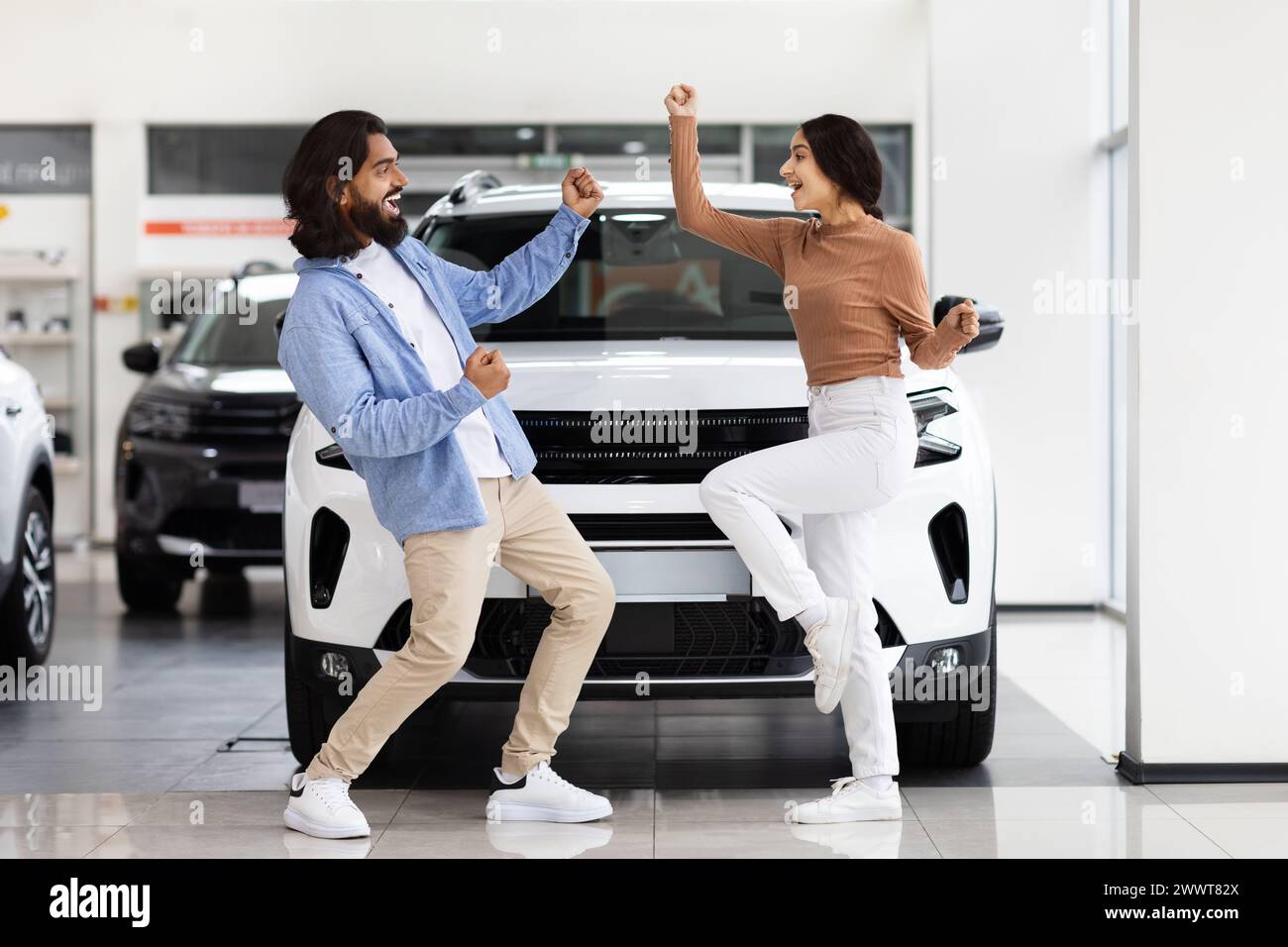 Two people celebrating a new car purchase Stock Photo - Alamy