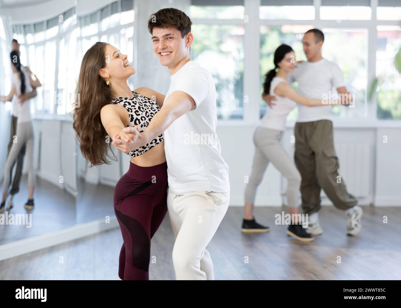 Young men and women dancing latin dances Stock Photo - Alamy