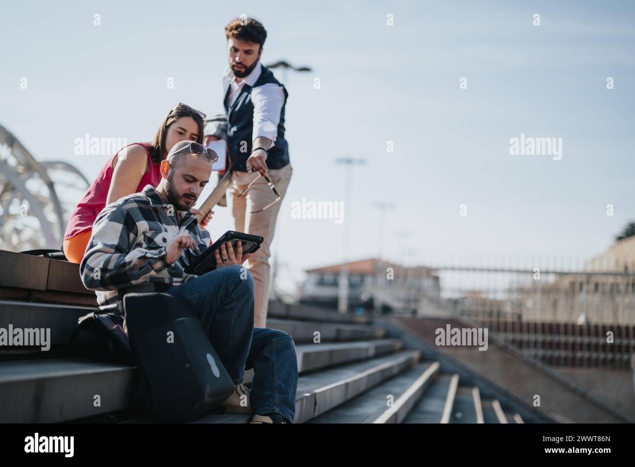 Dynamic business partners collaborating in an urban outdoor setting ...