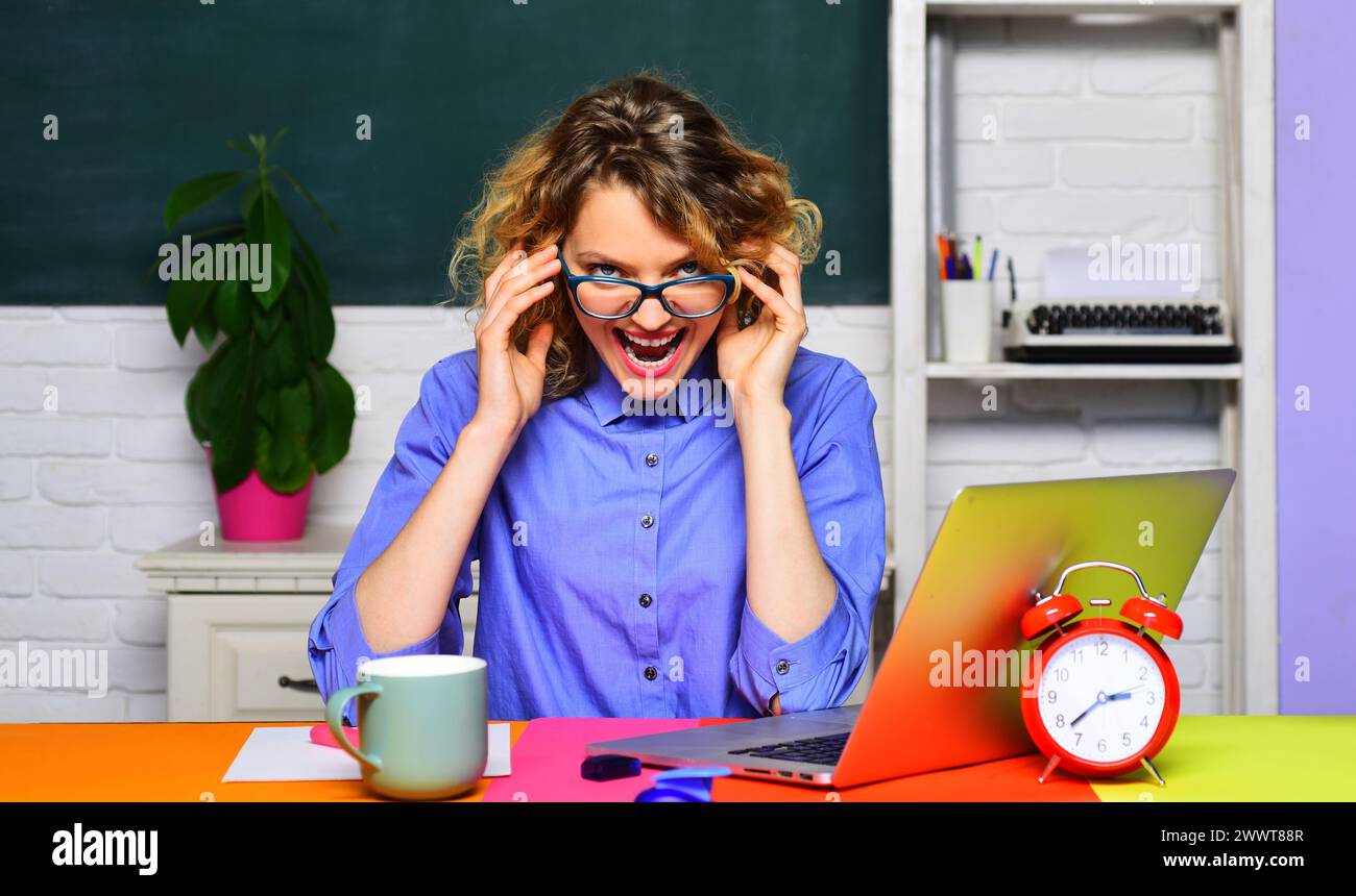 Funny female teacher or student in glasses in classroom. School teacher ...