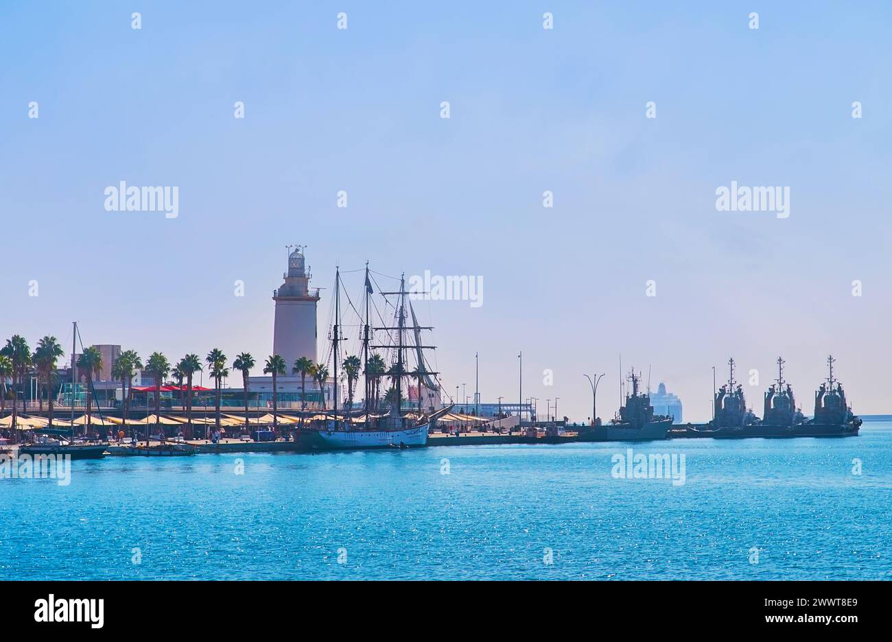 Malaga port with La Farola lighthouse, yachts and ships, Costa Del Sol ...