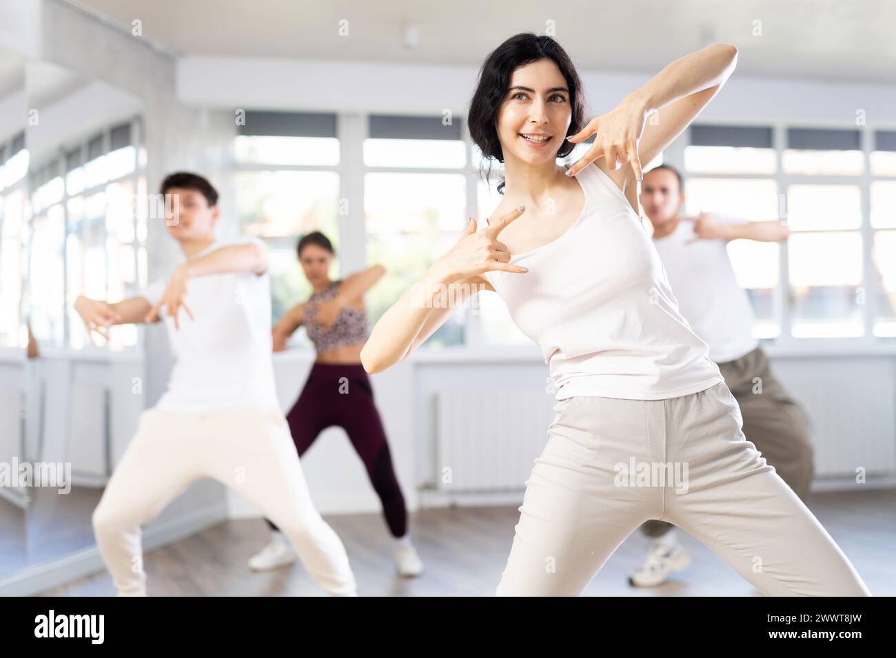 Girl enjoys active dancing, learns new movements, moves synchronously ...