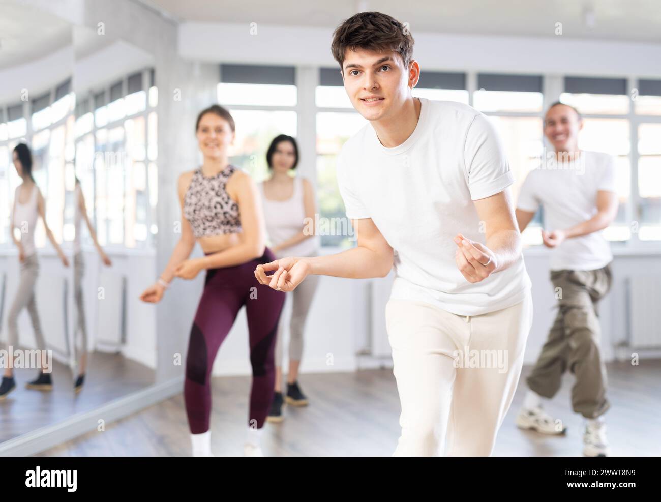 Group of happy young people enjoying a contemporary dancing class. Team ...