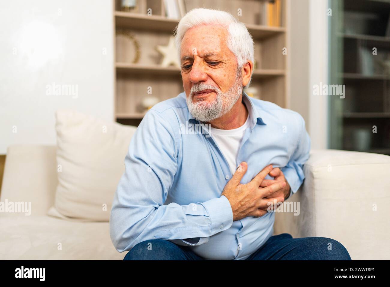 Pain on heart, heart attack. Unhappy middle aged senior man suffering ...