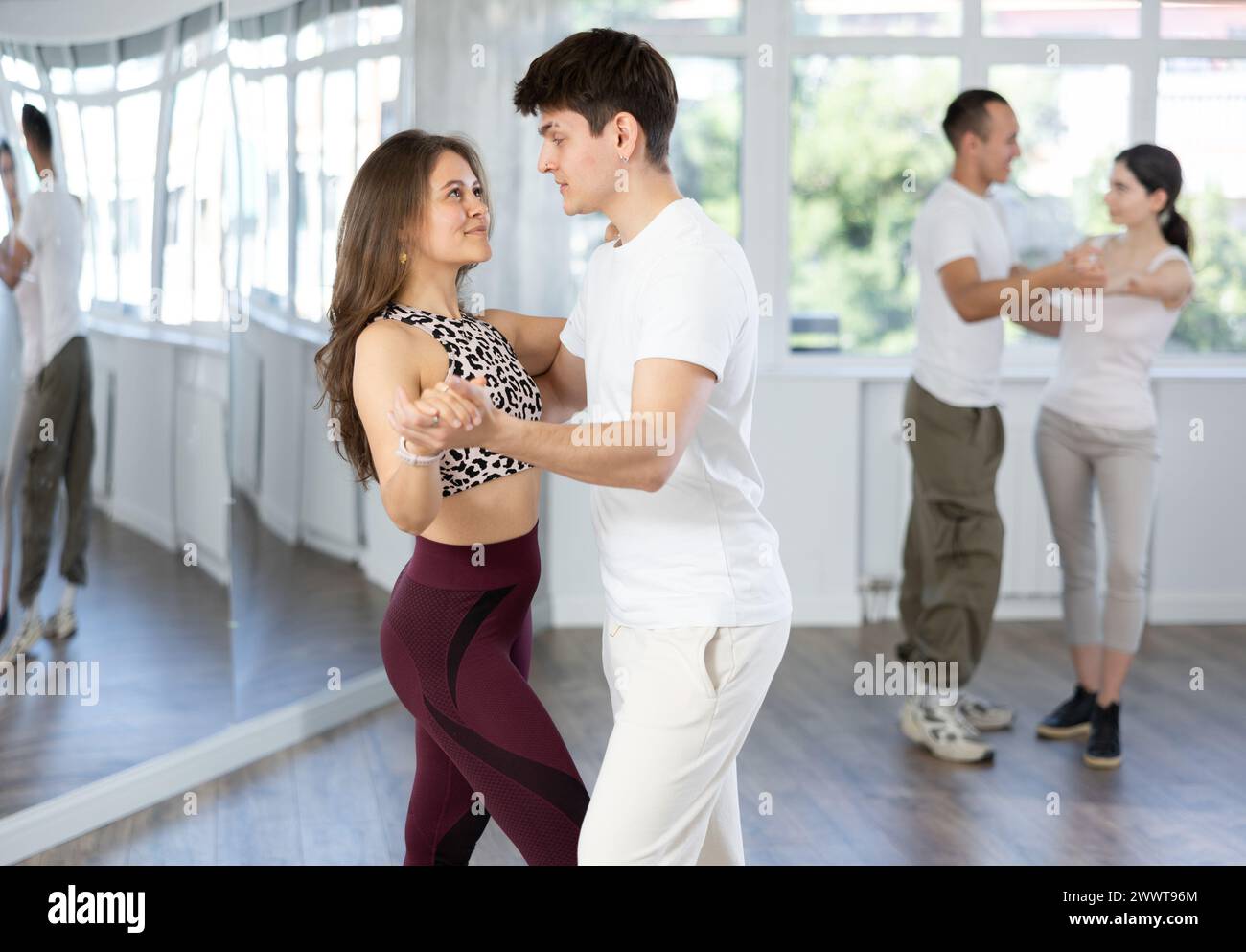 Dance studio - students in casual clothes learn to dance tango Stock ...