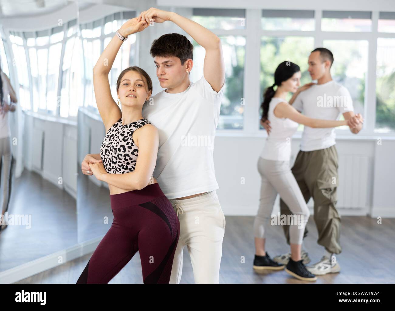 Girl paired up with young man, they train to perform disco fox dance ...