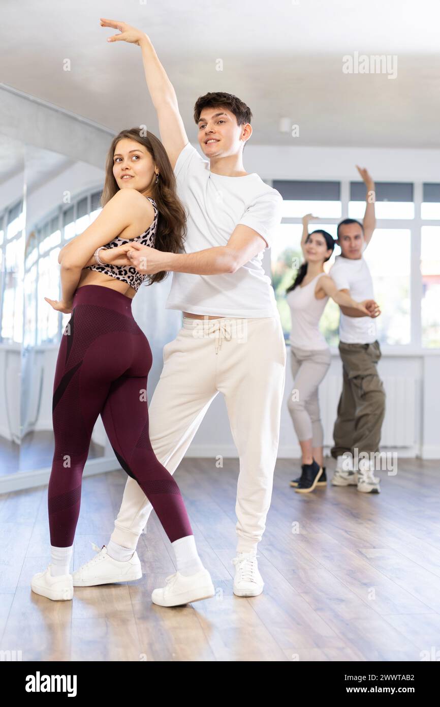 Girl paired up with young man, they train to perform disco fox dance ...